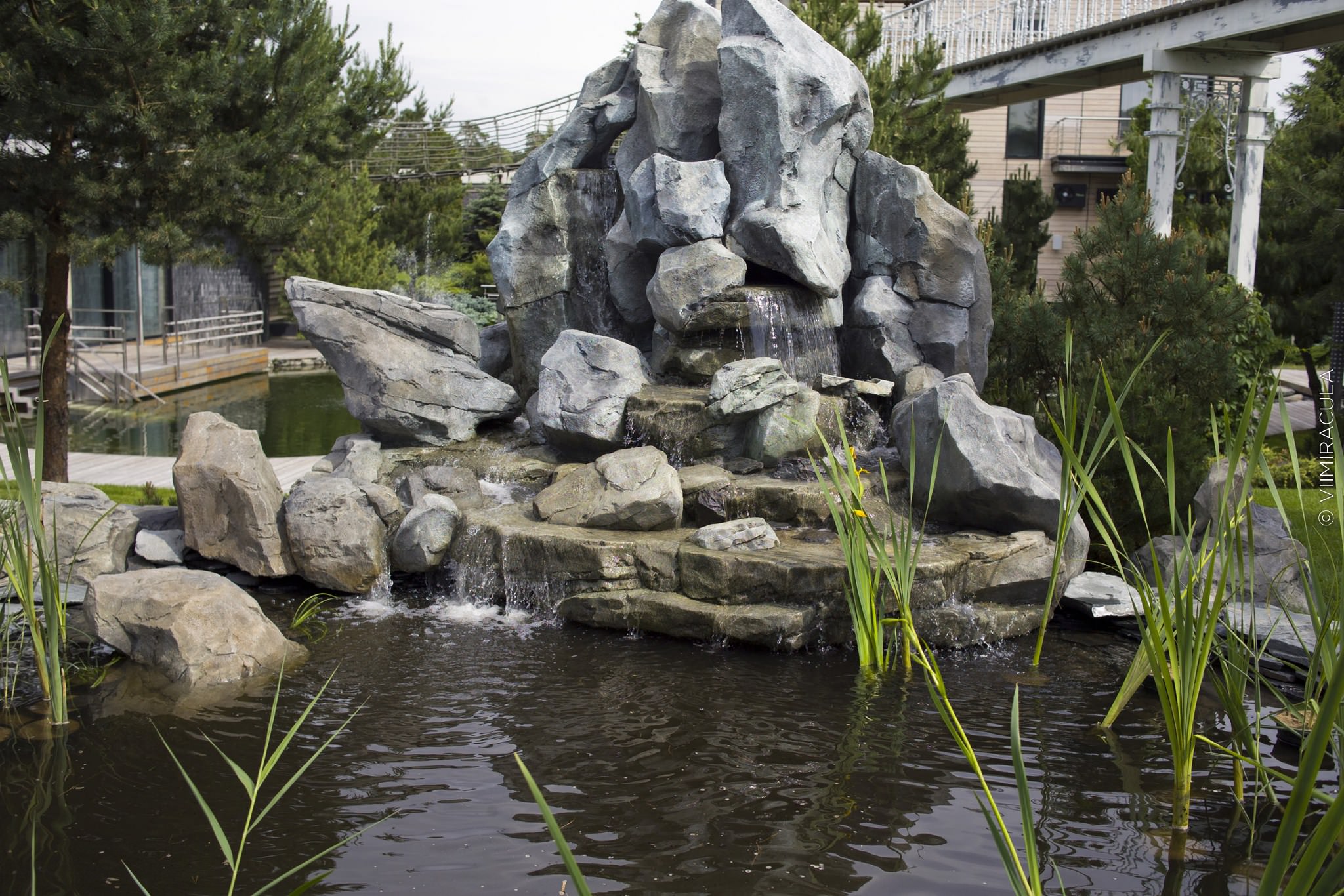 Garden pavilion and concrete waterfall